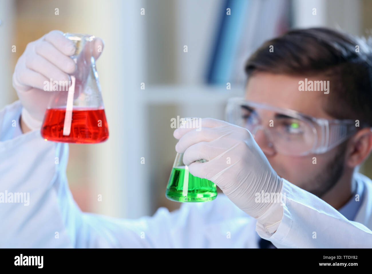 Man in laboratory checking test tubes Stock Photo - Alamy