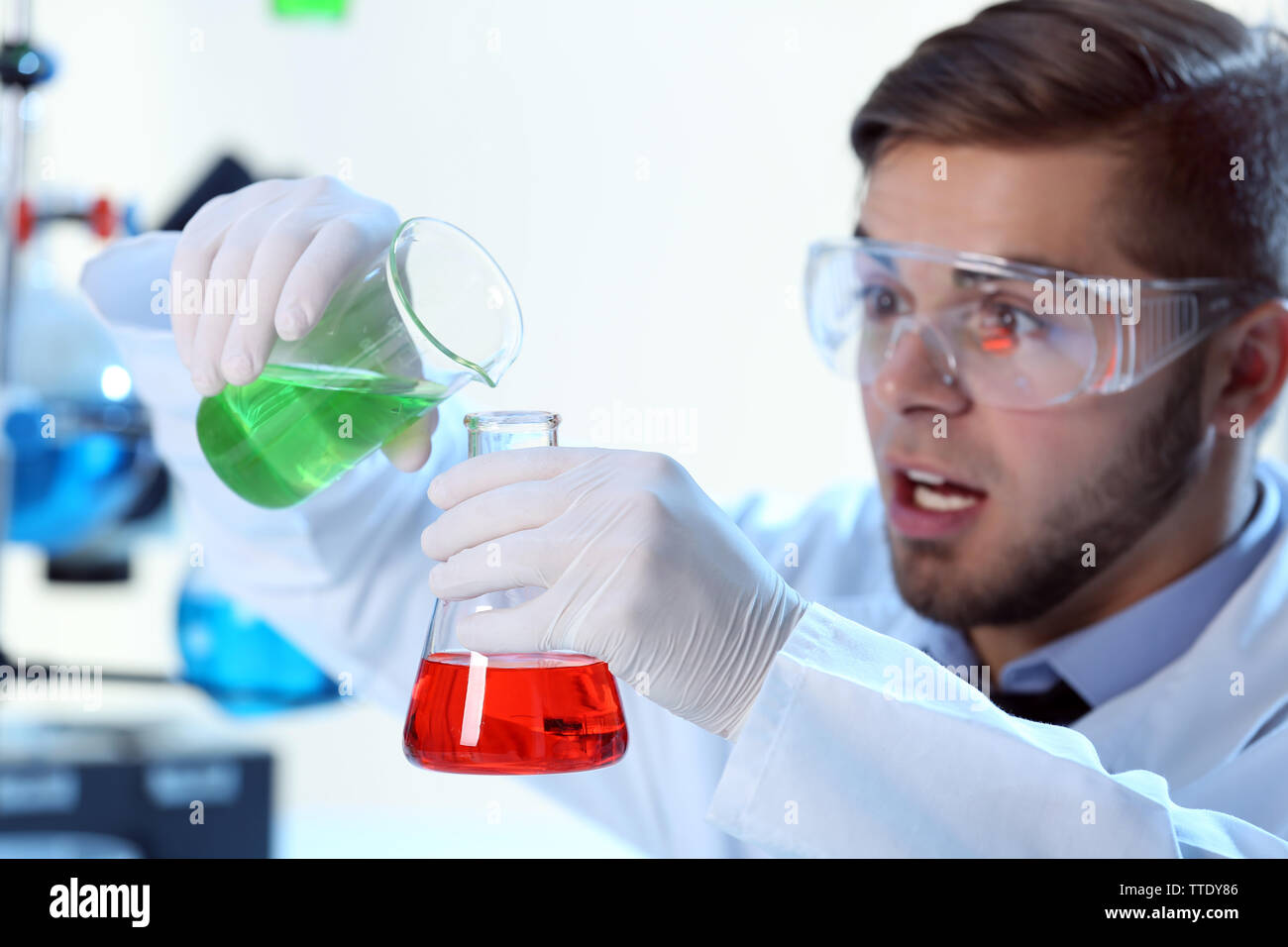 Man in laboratory checking test tubes Stock Photo - Alamy