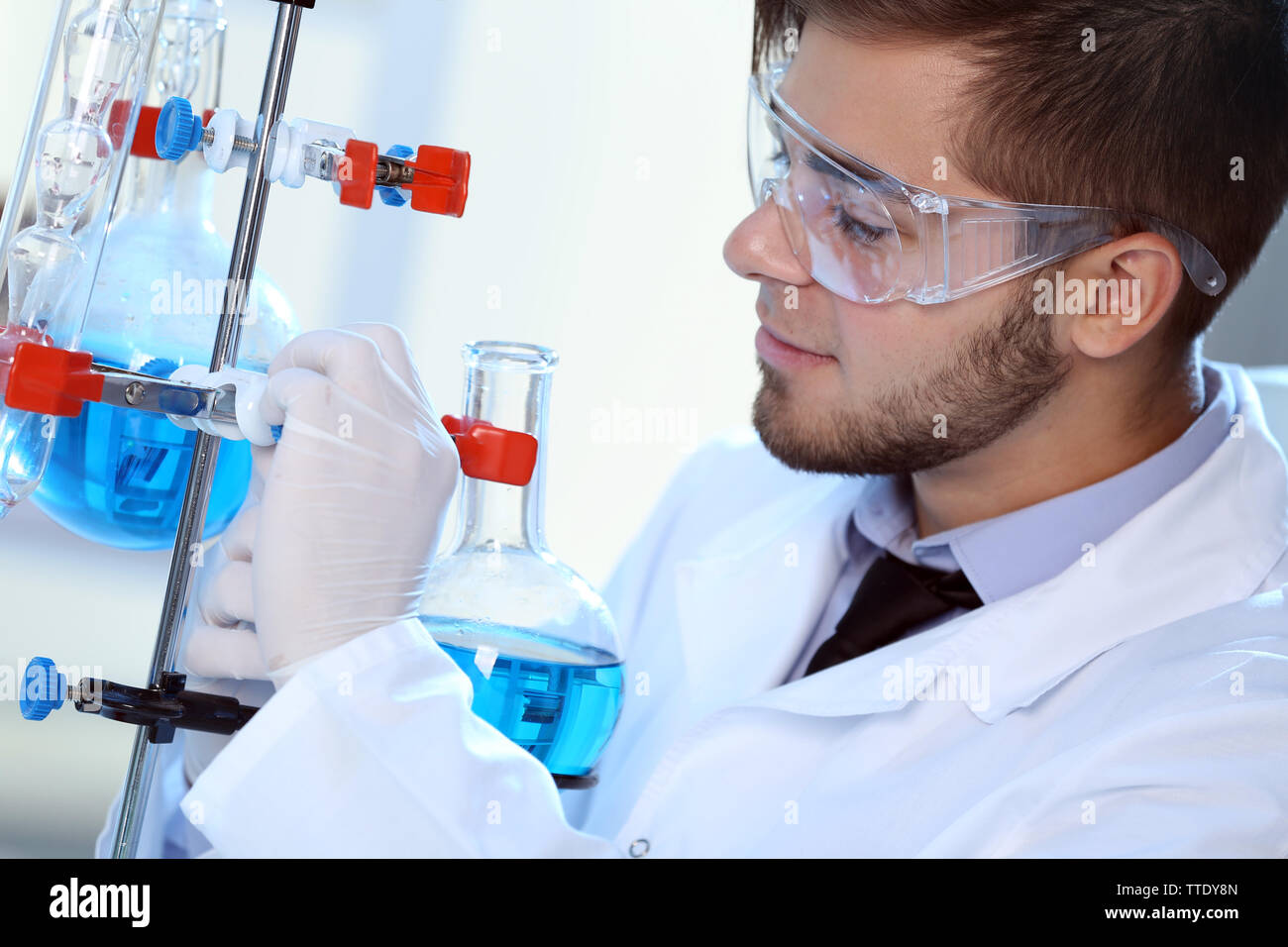 Man in laboratory checking test tubes Stock Photo - Alamy