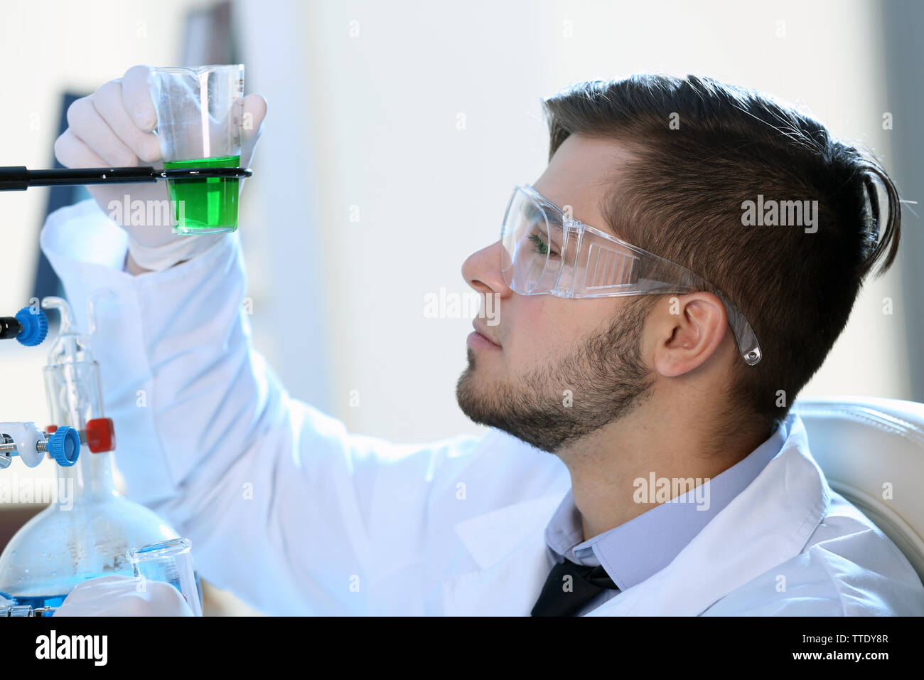 Man in laboratory checking test tubes Stock Photo - Alamy