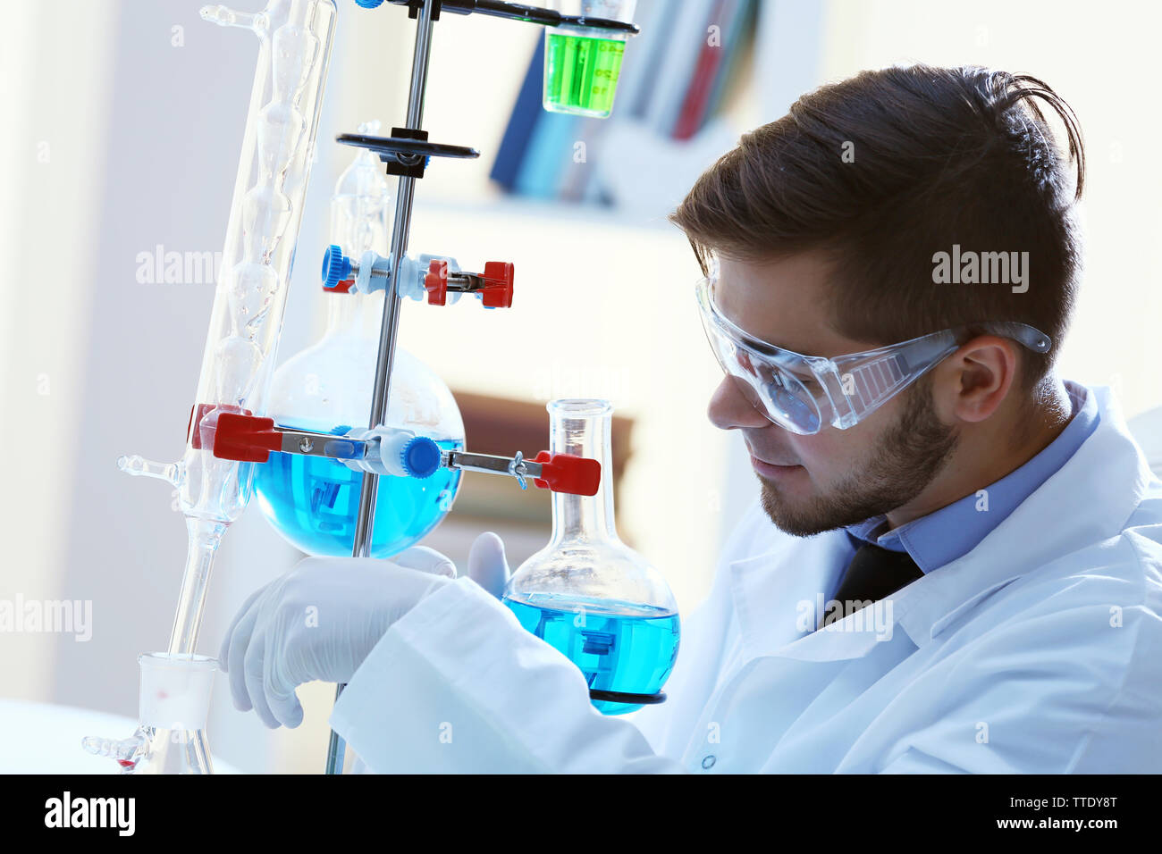 Man in laboratory checking test tubes Stock Photo - Alamy