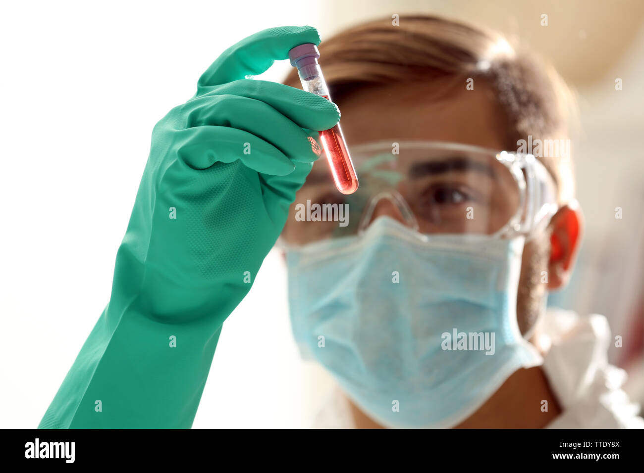 Man in laboratory checking test tubes Stock Photo - Alamy