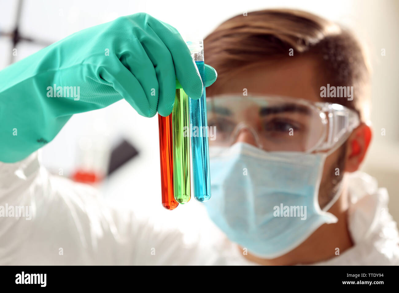Man in laboratory checking test tubes Stock Photo - Alamy