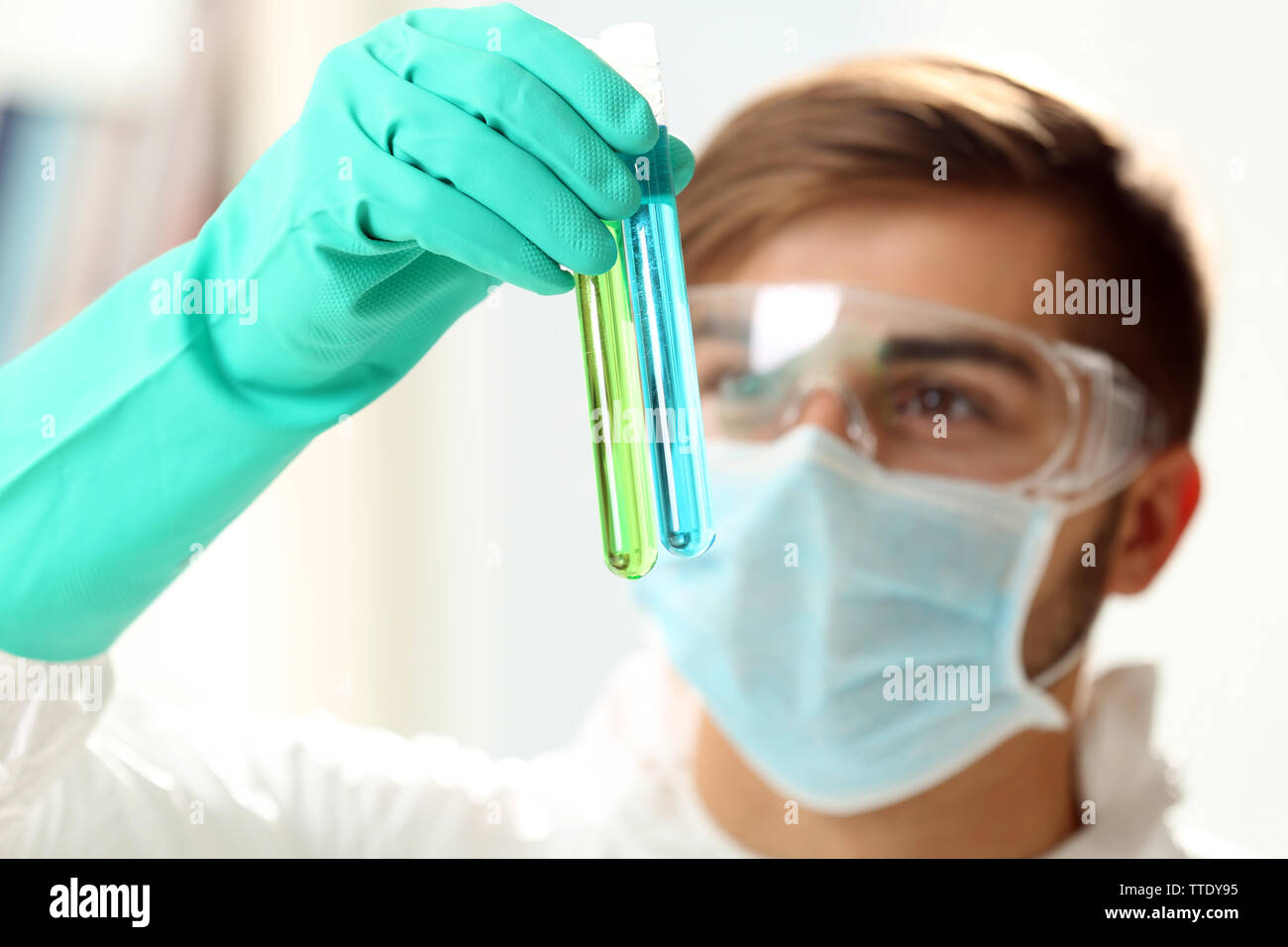 Man in laboratory checking test tubes Stock Photo - Alamy