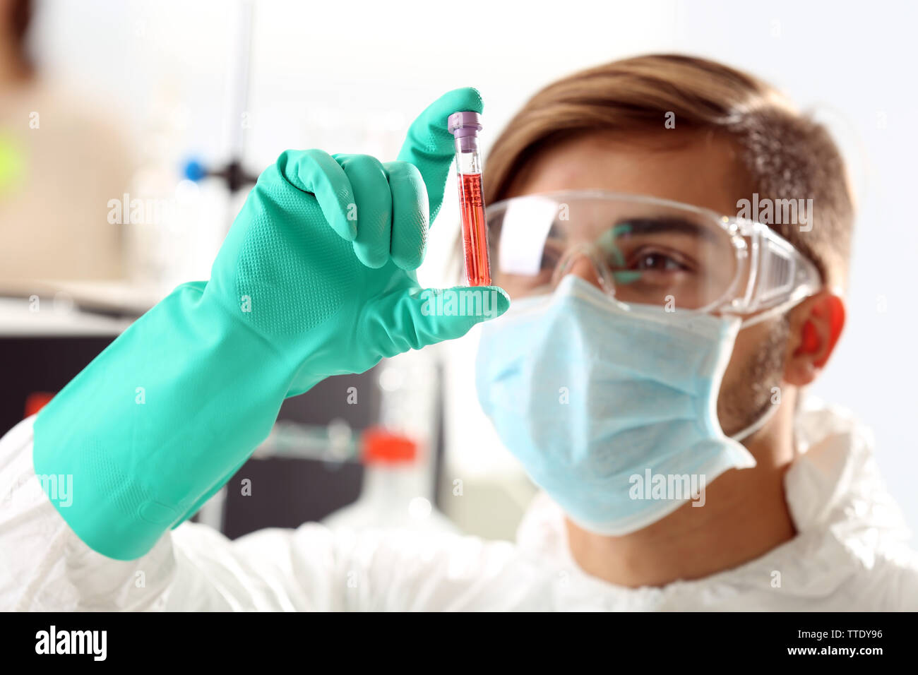 Man in laboratory checking test tubes Stock Photo - Alamy