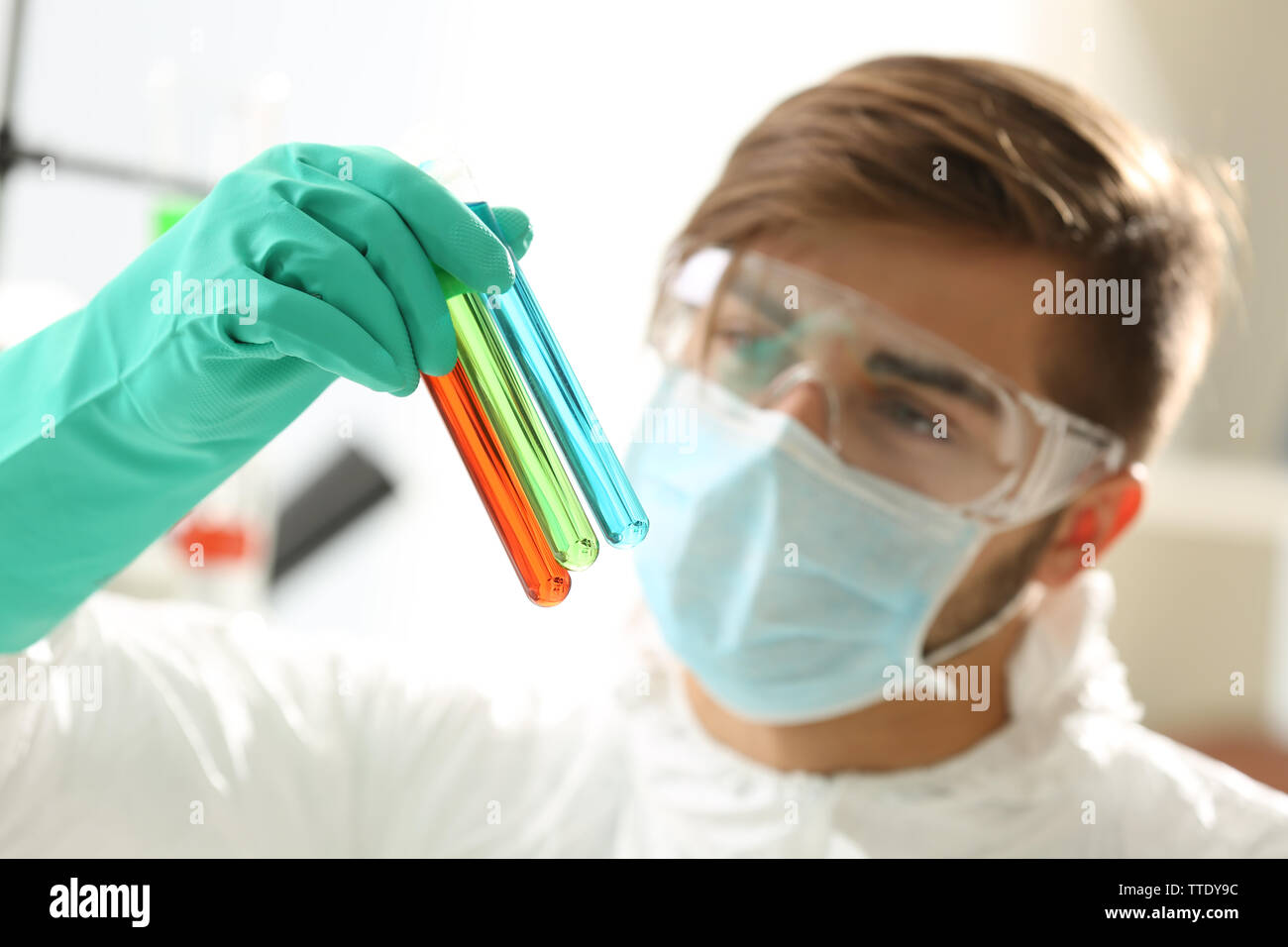 Man in laboratory checking test tubes Stock Photo - Alamy
