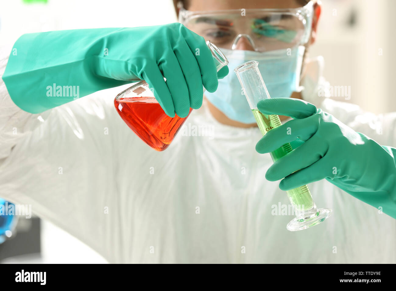 Man in laboratory checking test tubes Stock Photo - Alamy