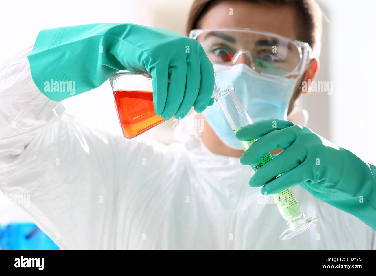 Man in laboratory checking test tubes Stock Photo - Alamy