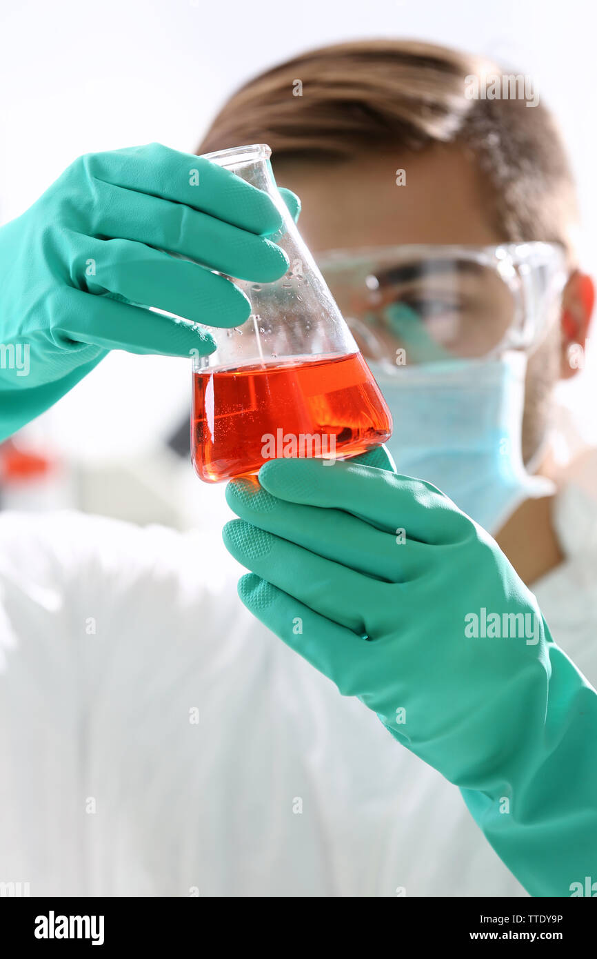 Man in laboratory checking test tubes Stock Photo - Alamy
