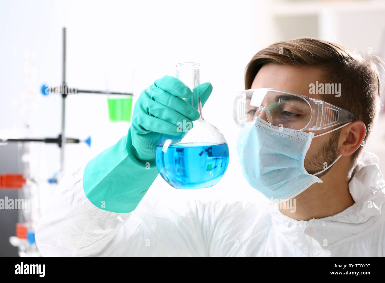 Man in laboratory checking test tubes Stock Photo - Alamy