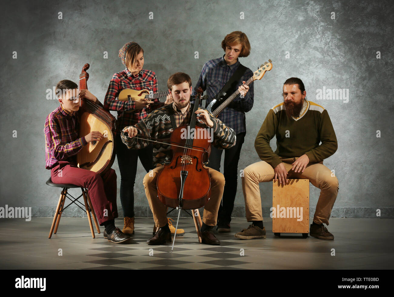 Musical band on grey wall background Stock Photo - Alamy