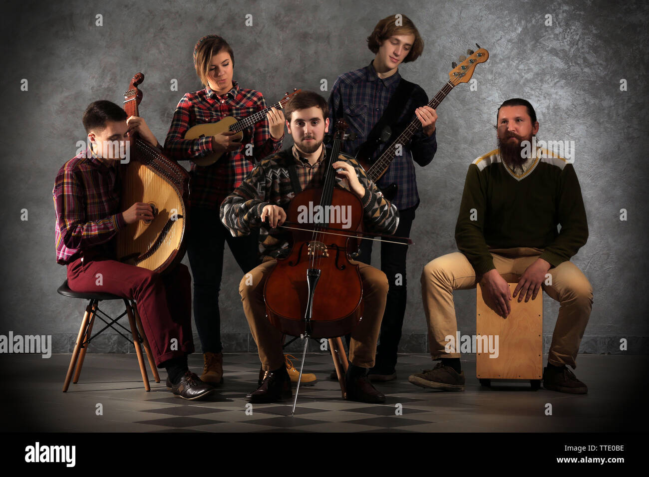 Musical band on grey wall background Stock Photo - Alamy
