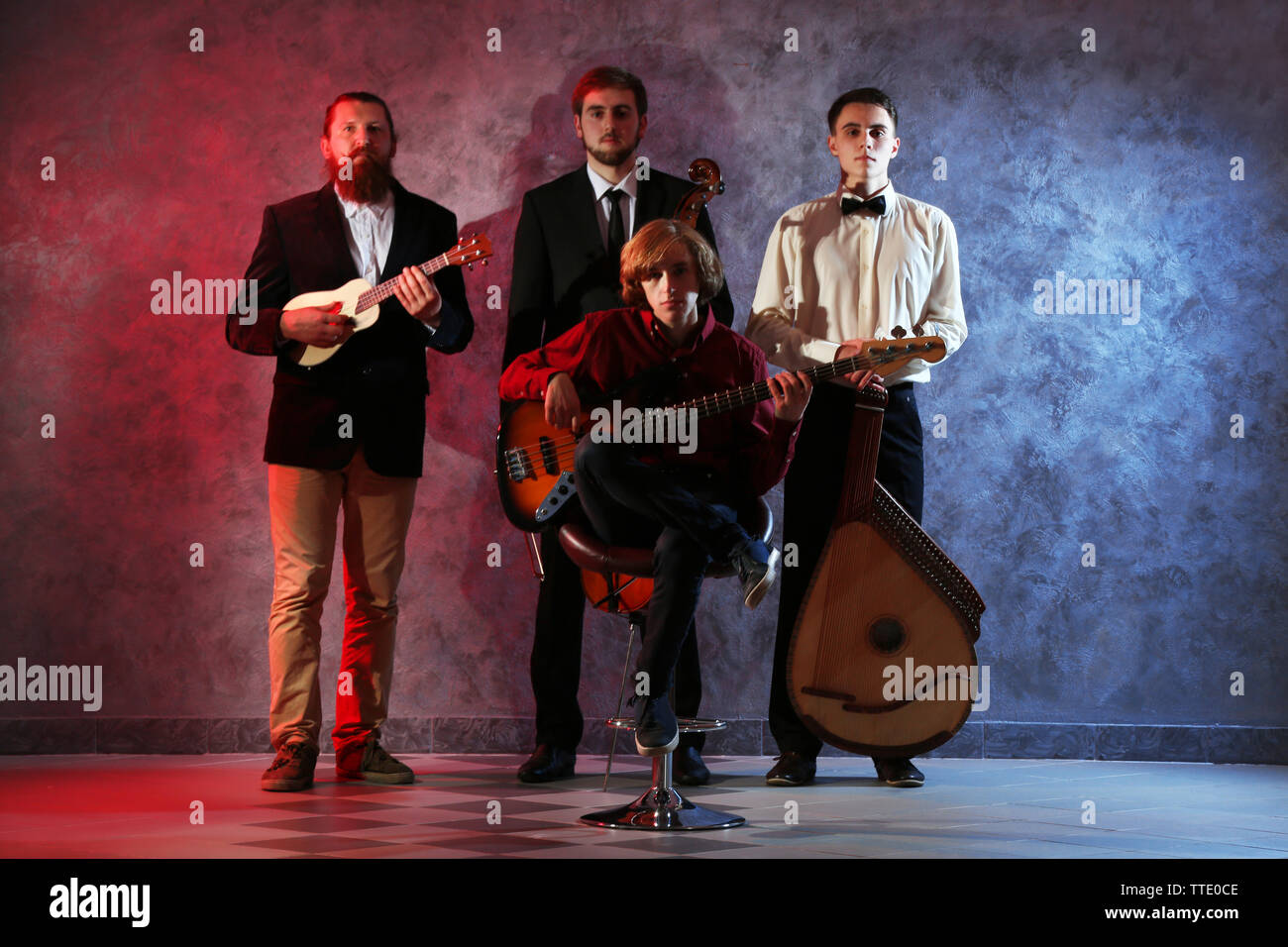 Man's musical band on grey wall background Stock Photo - Alamy