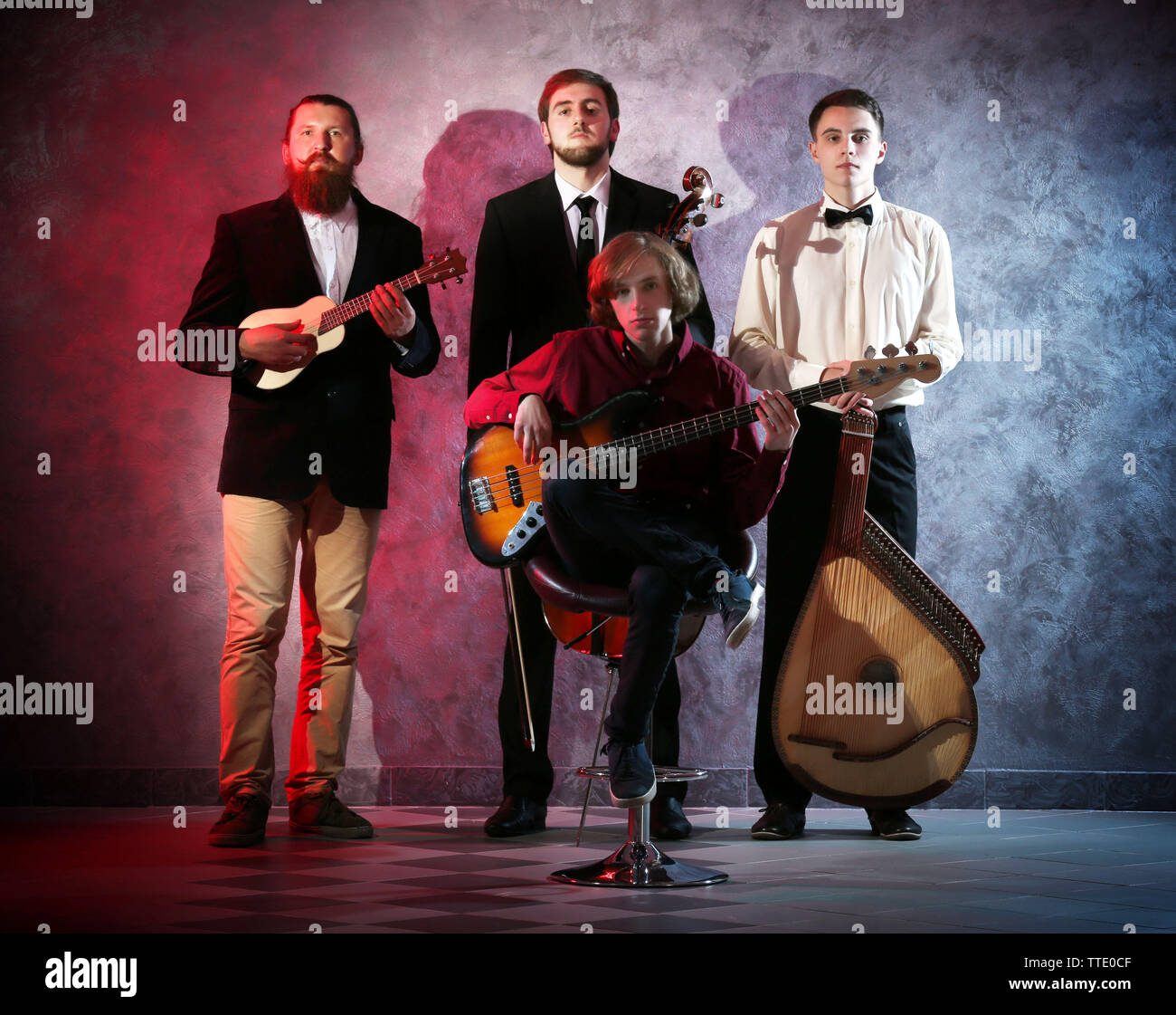 Man's musical band on grey wall background Stock Photo - Alamy
