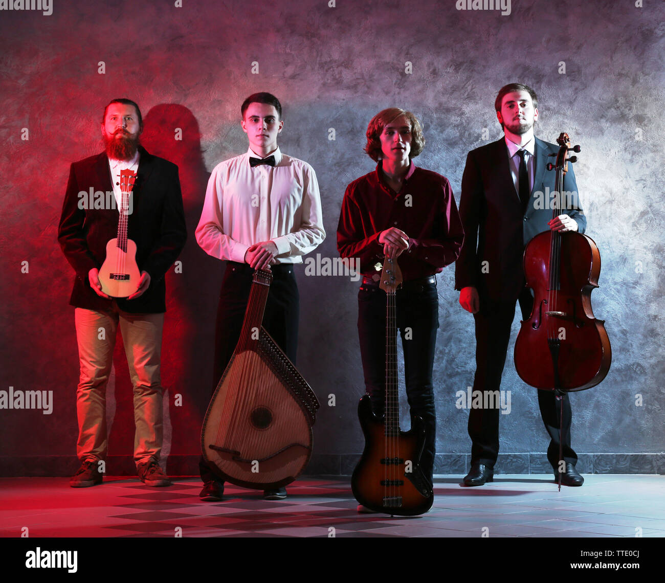 Man's musical band on grey wall background Stock Photo - Alamy