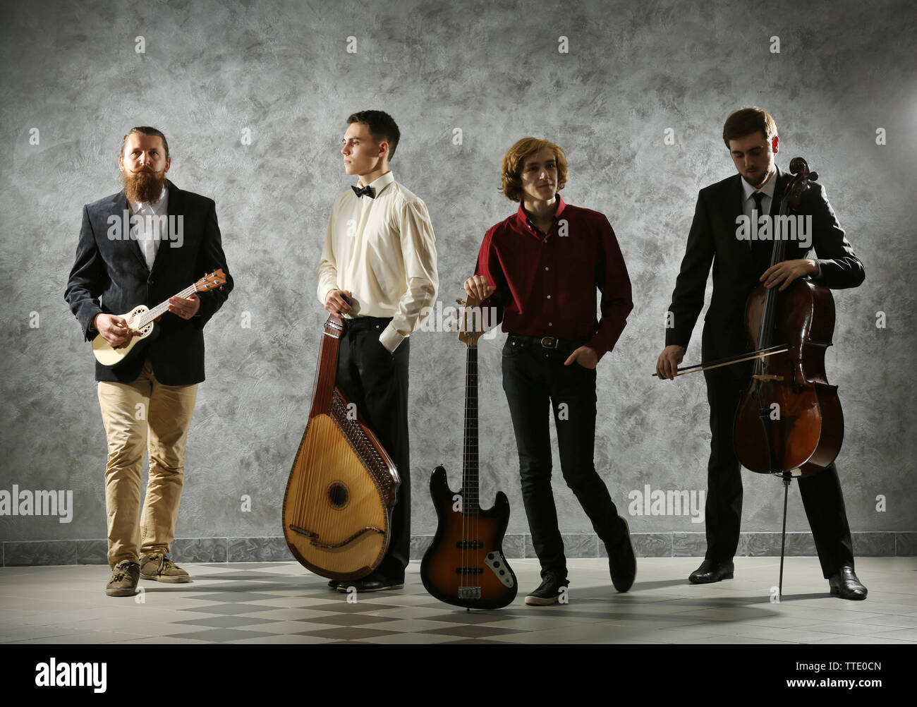Man's musical band on grey wall background Stock Photo - Alamy