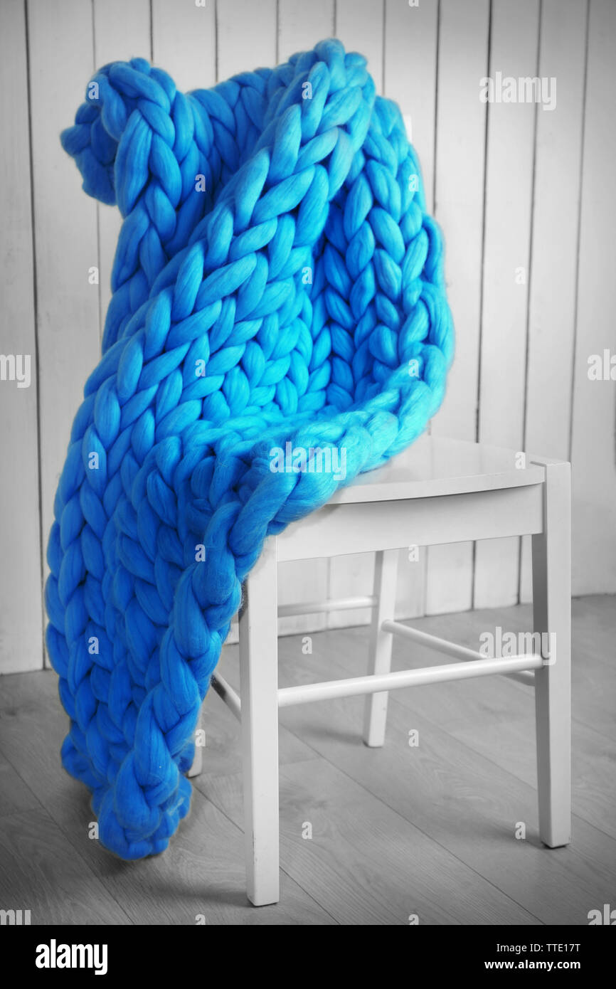 Knitted woolen blanket on chair, on home interior background Stock ...