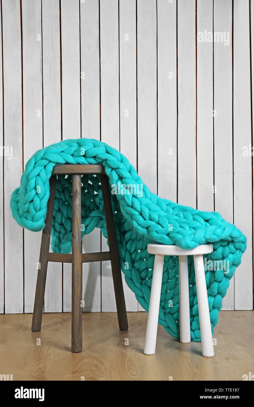 Knitted woolen blanket on chair, on home interior background Stock ...