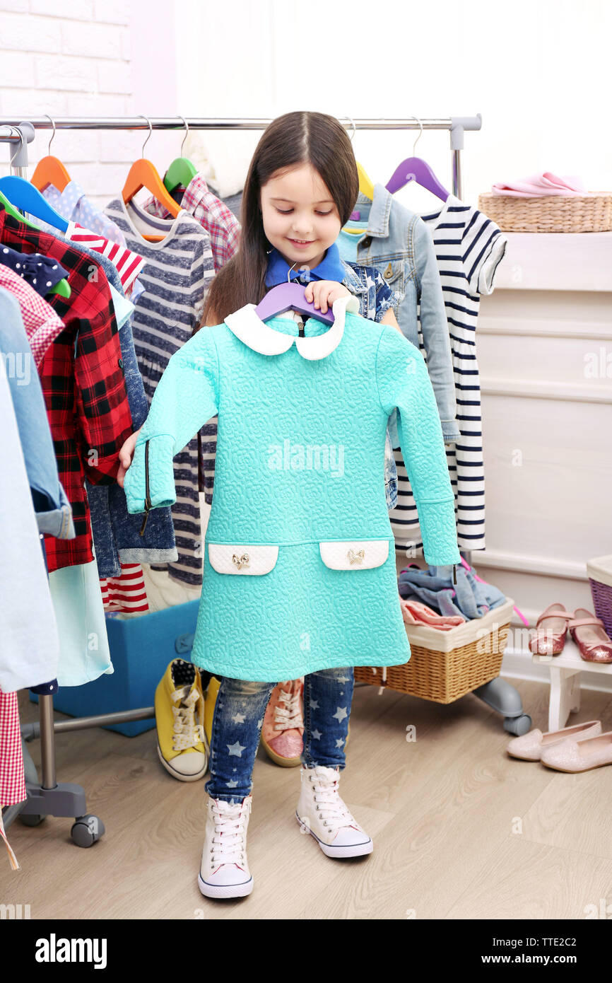 Little girl trying on a new dress Stock Photo - Alamy