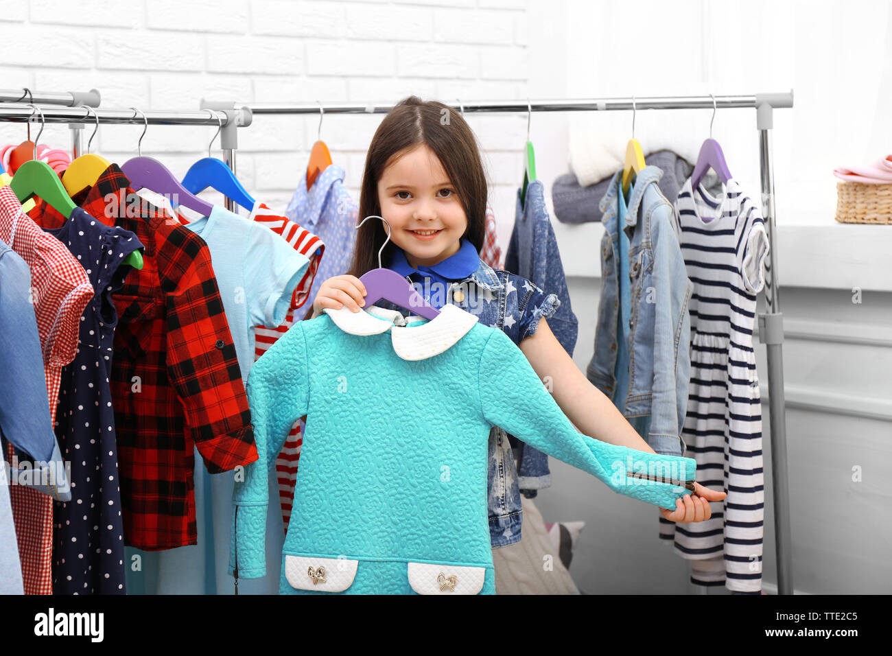 Little girl trying on a new dress Stock Photo - Alamy