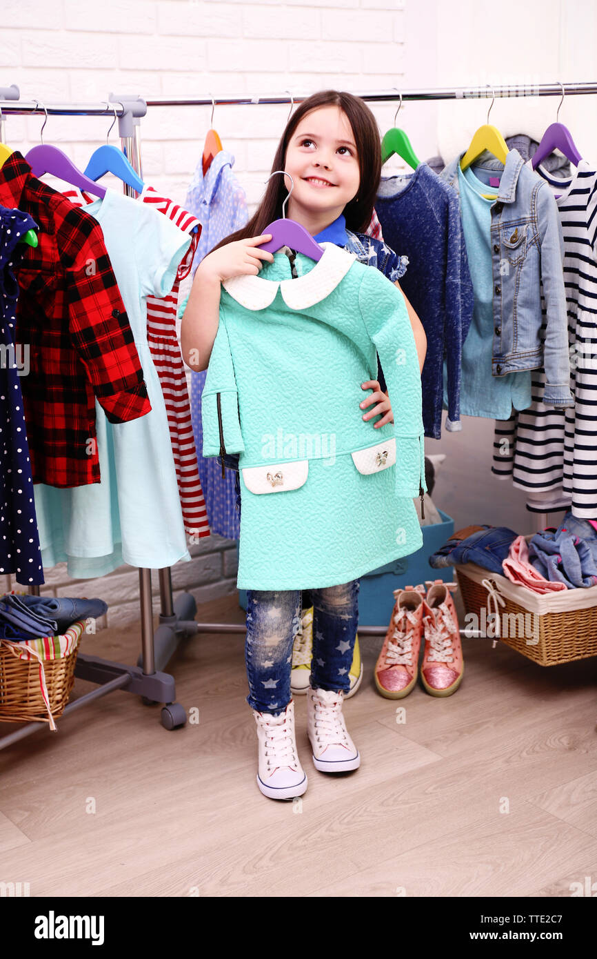 Little girl trying on a new dress Stock Photo - Alamy