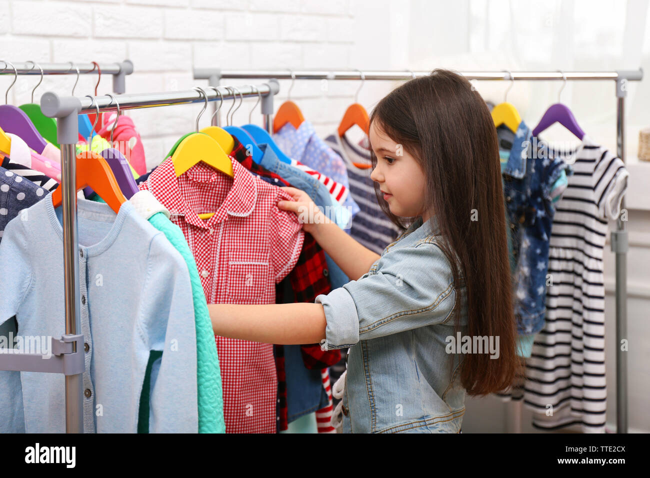 Little girl trying on a new dress Stock Photo - Alamy