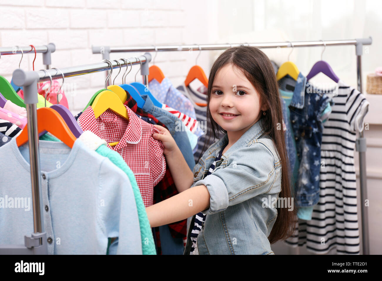 Little girl trying on a new dress Stock Photo - Alamy