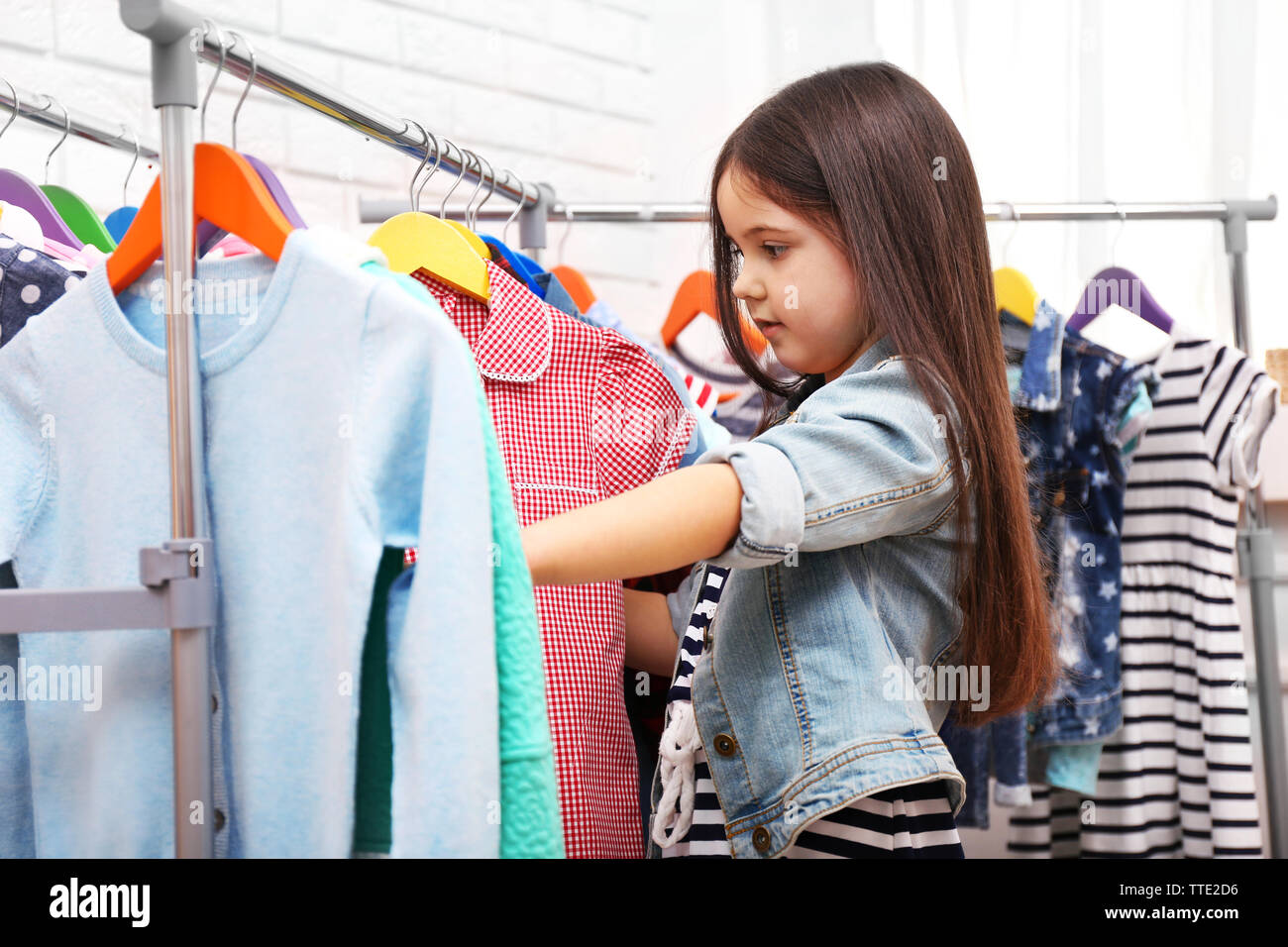 Little girl trying on a new dress Stock Photo - Alamy