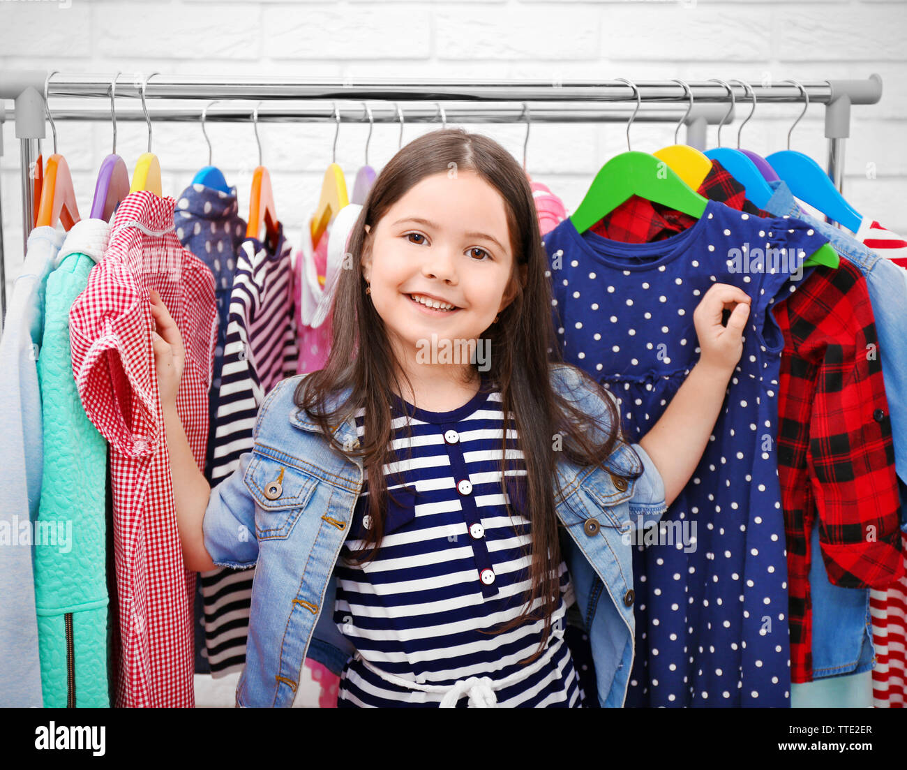 Little girl trying on a new dress Stock Photo - Alamy