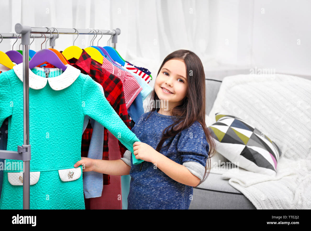 Little girl trying on a new shirt Stock Photo - Alamy