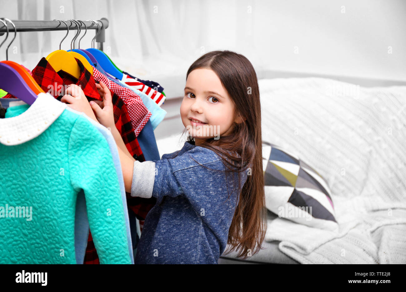 Little girl trying on a new shirt Stock Photo - Alamy