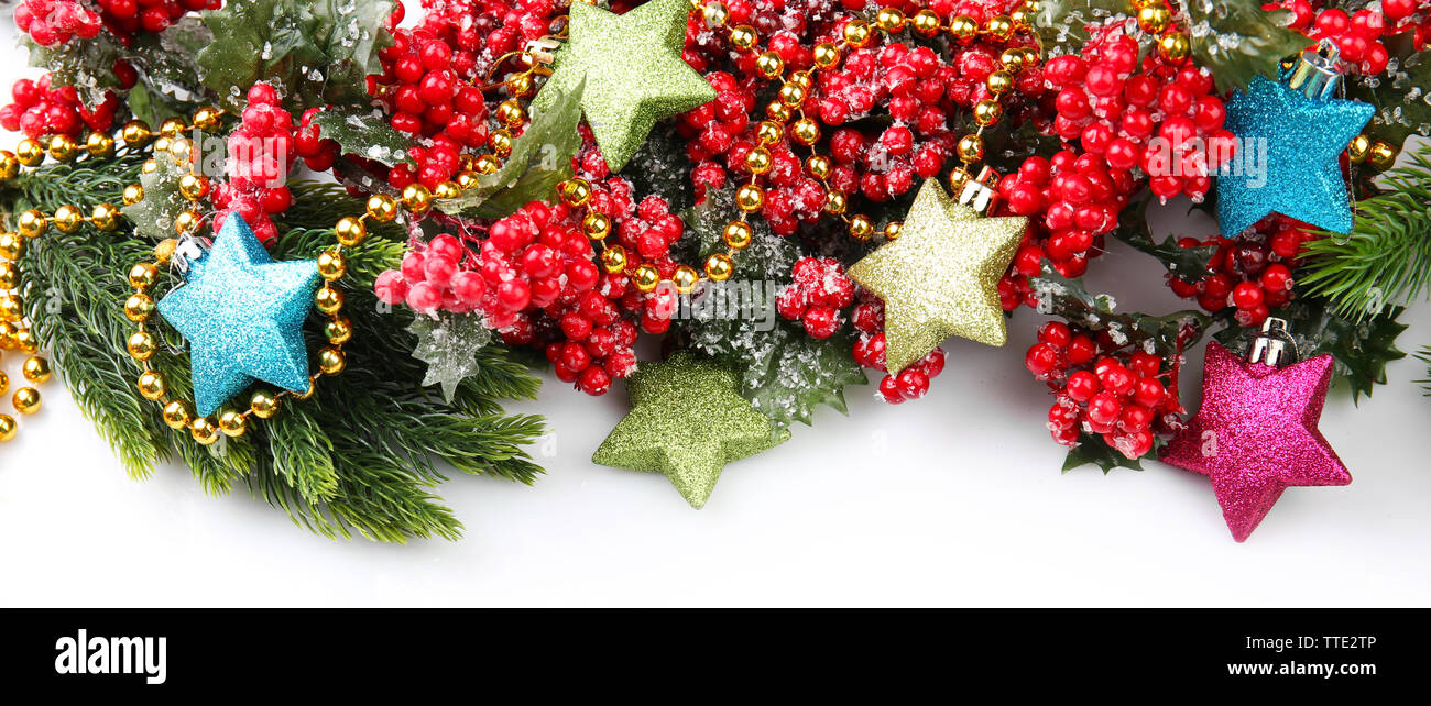 Christmas tree branch with red berries and decorations on white ...