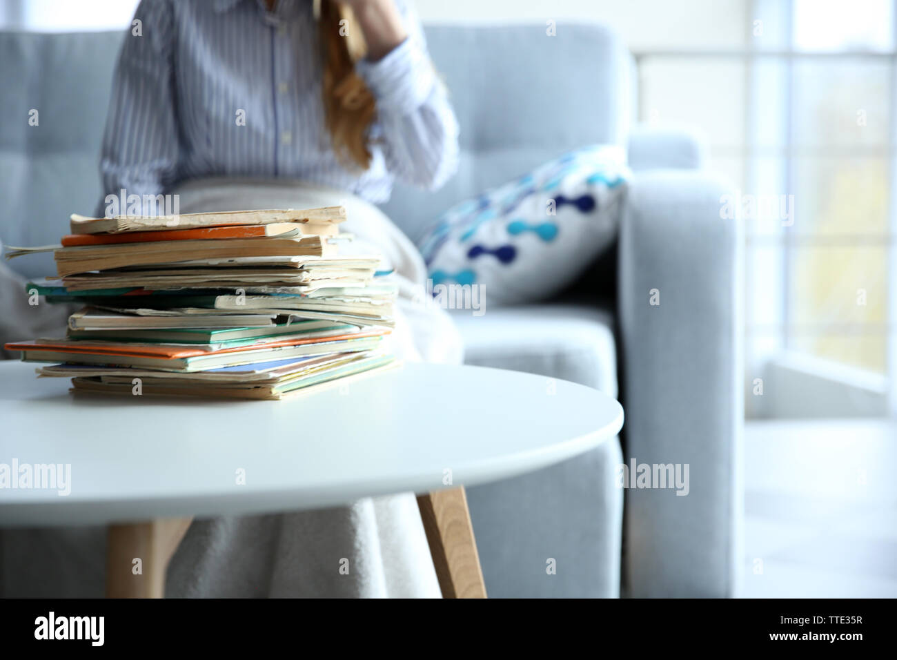Pile of old books on white table. Woman throws books from table Stock ...