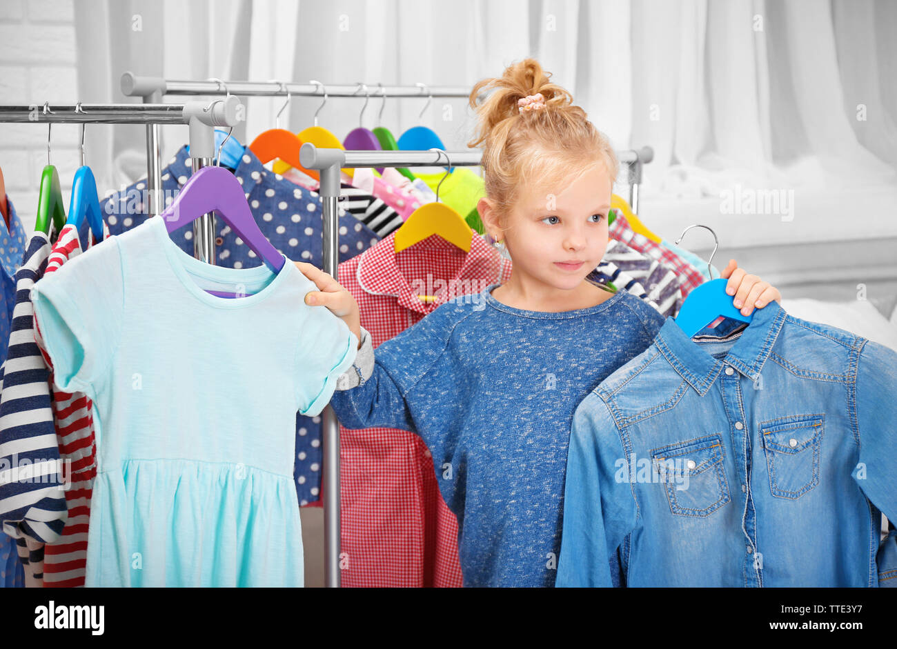 Little girl trying on a new clothes Stock Photo - Alamy