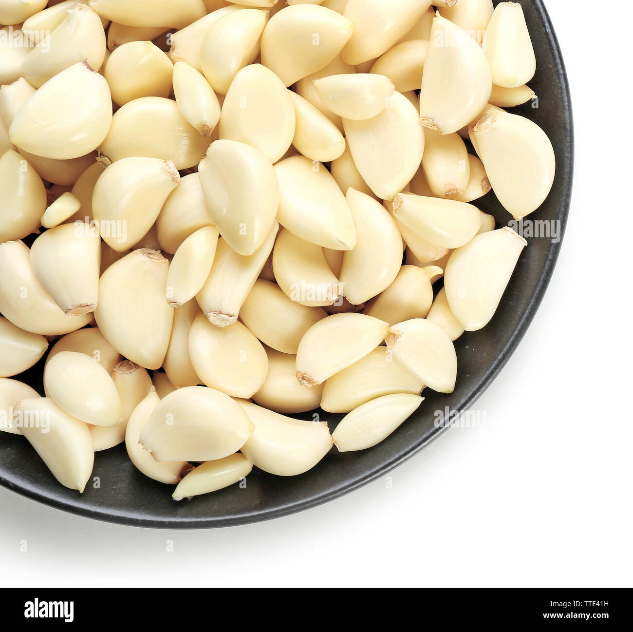 Garlic in bowl isolated on white Stock Photo - Alamy