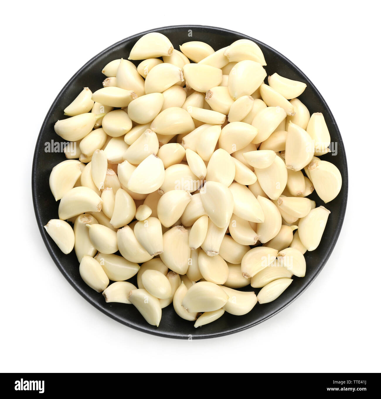 Garlic in bowl isolated on white Stock Photo - Alamy