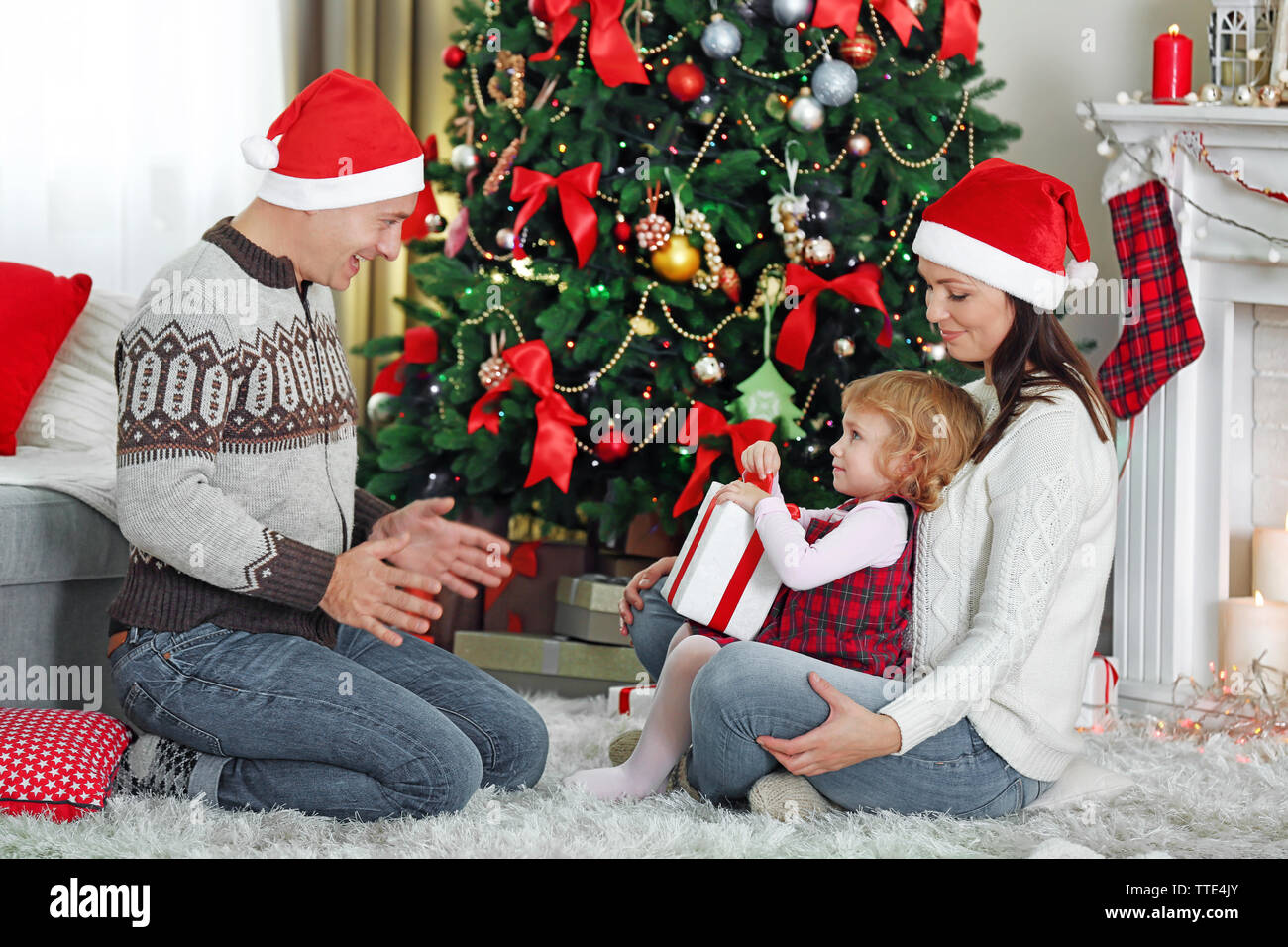 Happy Family on Christmas tree background Stock Photo - Alamy