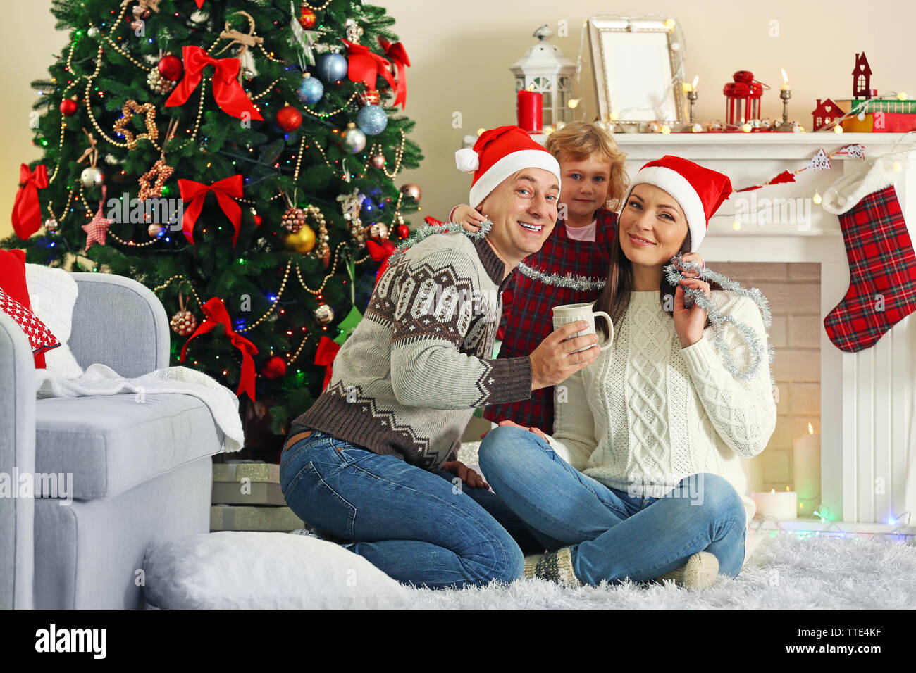 Happy Family on Christmas tree background Stock Photo - Alamy