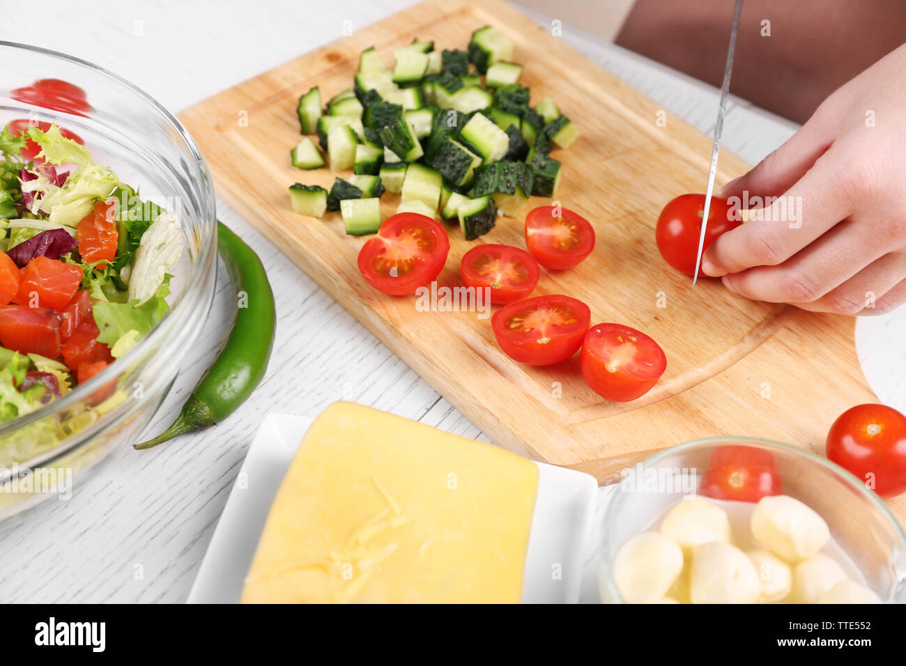 Female hands cutting vegetables for salad, at kitchen Stock Photo - Alamy