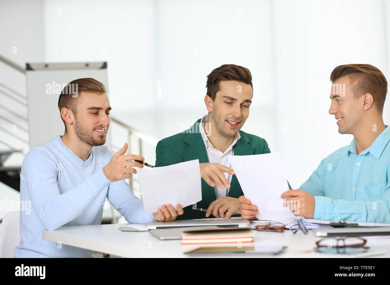 Young business men at the meeting in a conference room Stock Photo - Alamy