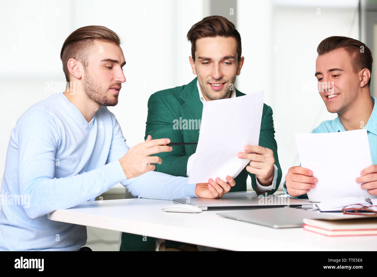 Young business men at the meeting in a conference room Stock Photo - Alamy