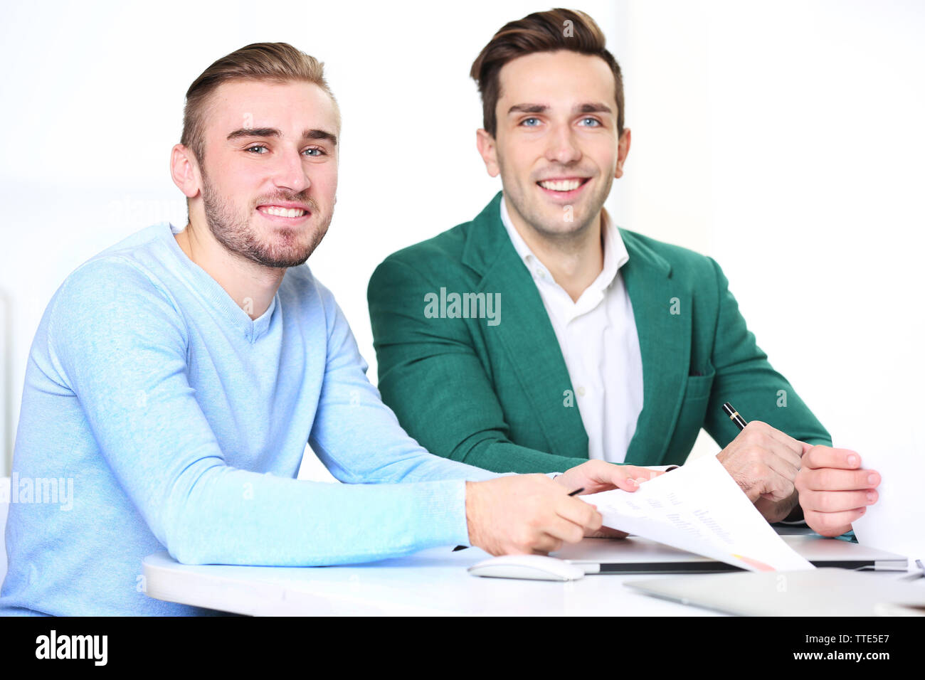 Young business men at the meeting in a conference room Stock Photo - Alamy