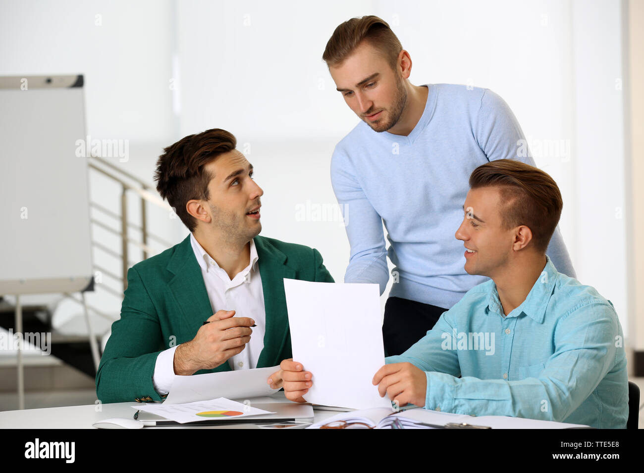 Young business men at the meeting in a conference room Stock Photo - Alamy