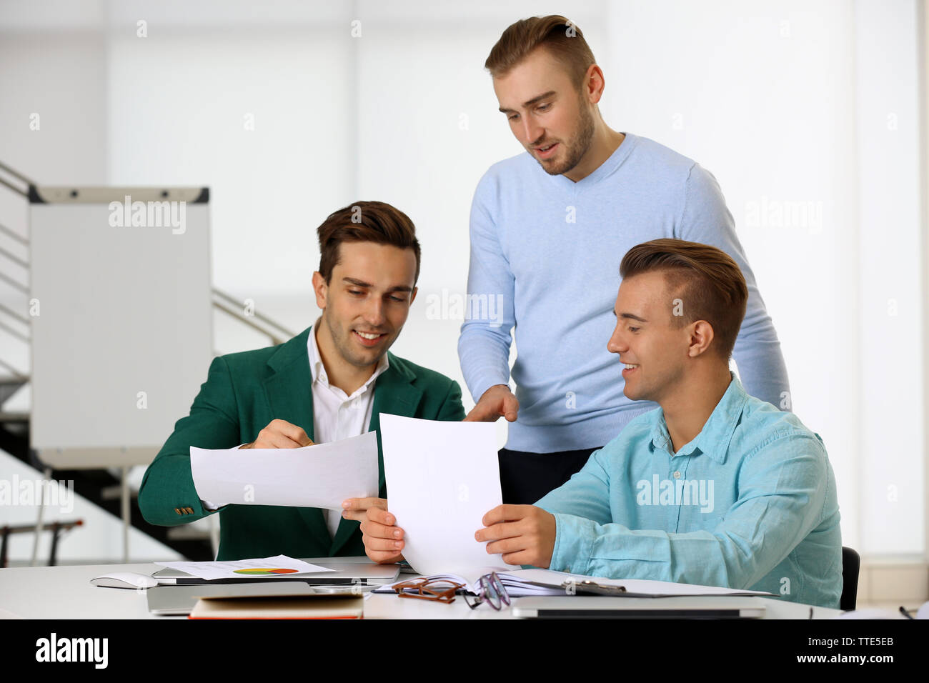 Young business men at the meeting in a conference room Stock Photo - Alamy