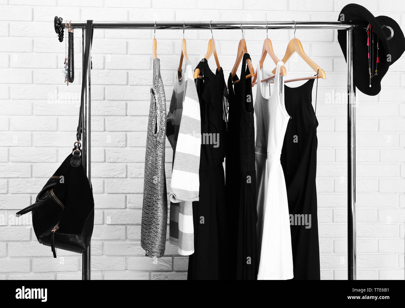 Collection of male and female clothes hanging on a rack Stock Photo - Alamy