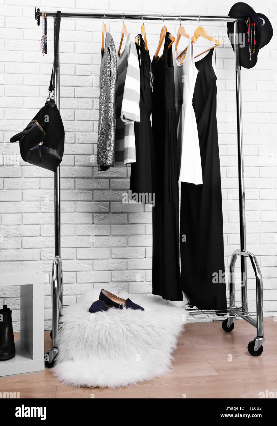 Collection of male and female clothes hanging on a rack Stock Photo - Alamy