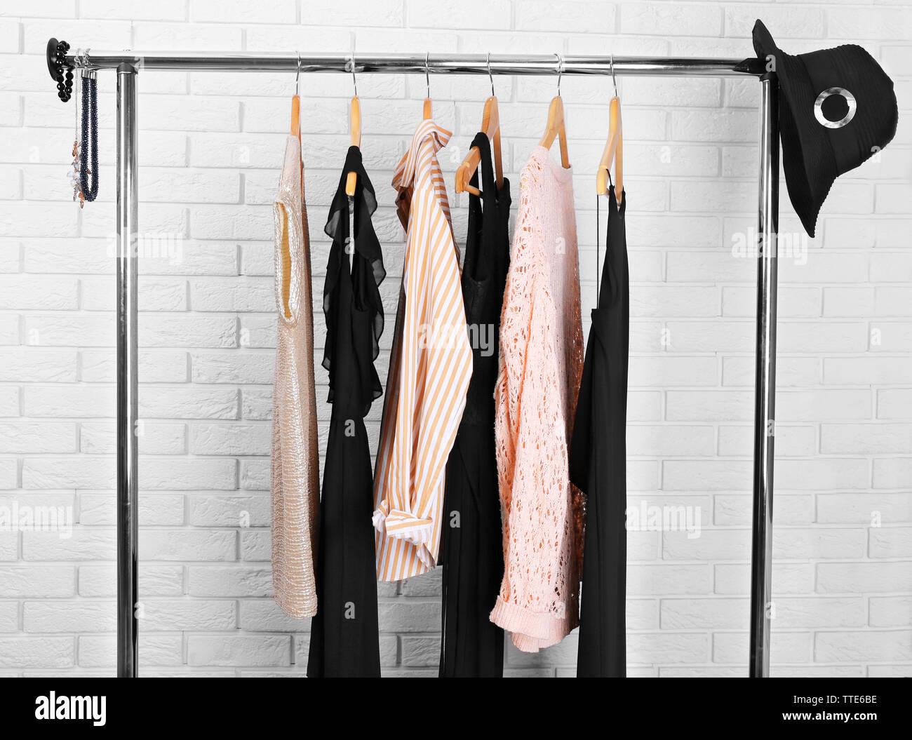 Collection of female clothes hanging on a rack Stock Photo - Alamy