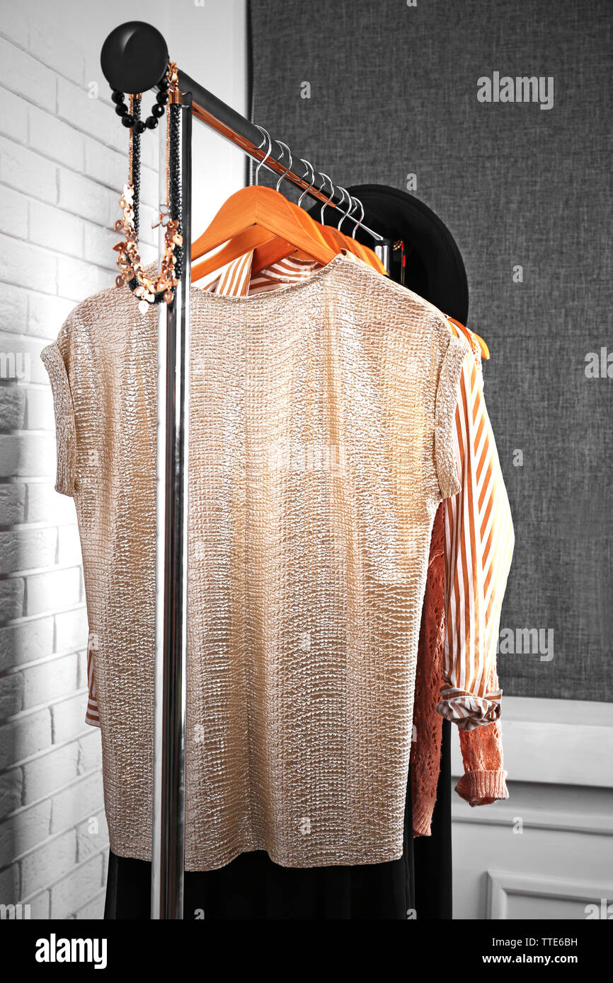 Collection of female clothes hanging on a rack Stock Photo - Alamy