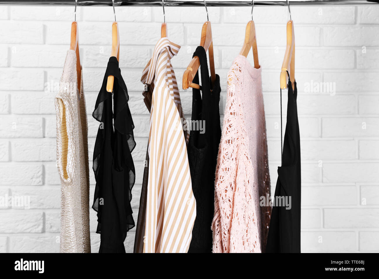 Collection of female clothes hanging on a rack Stock Photo - Alamy