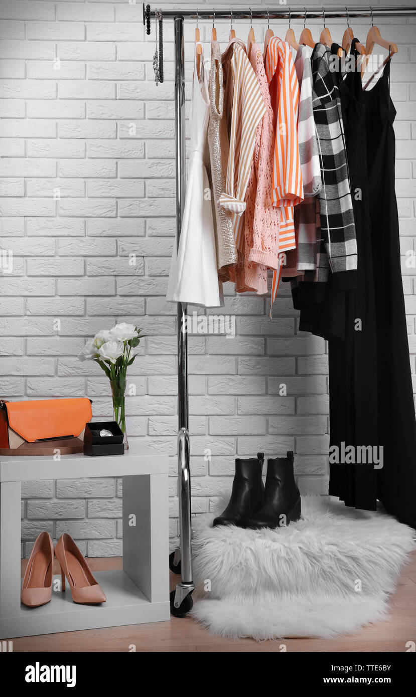 Collection of female clothes hanging on a rack Stock Photo - Alamy